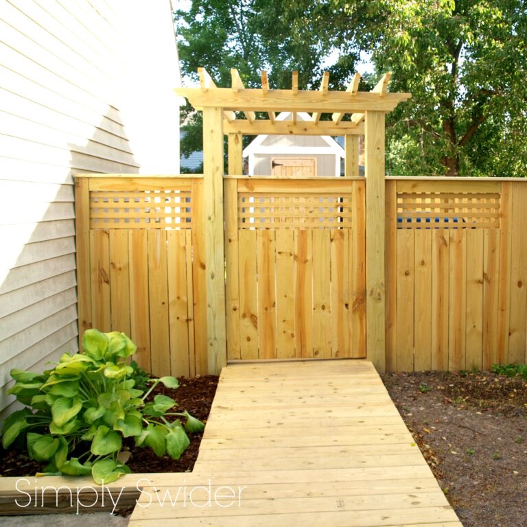 A beautiful fence and gate with an arbor - SimplySwider.com