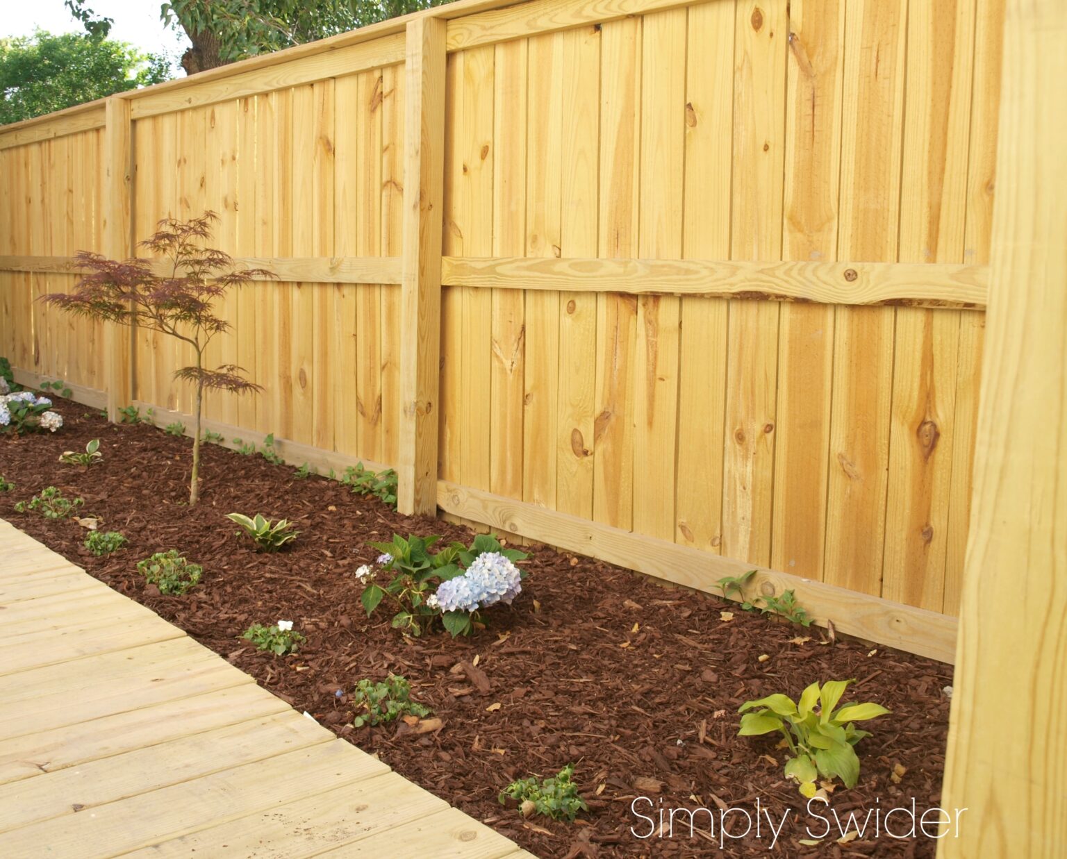 A beautiful fence and gate with an arbor - SimplySwider.com