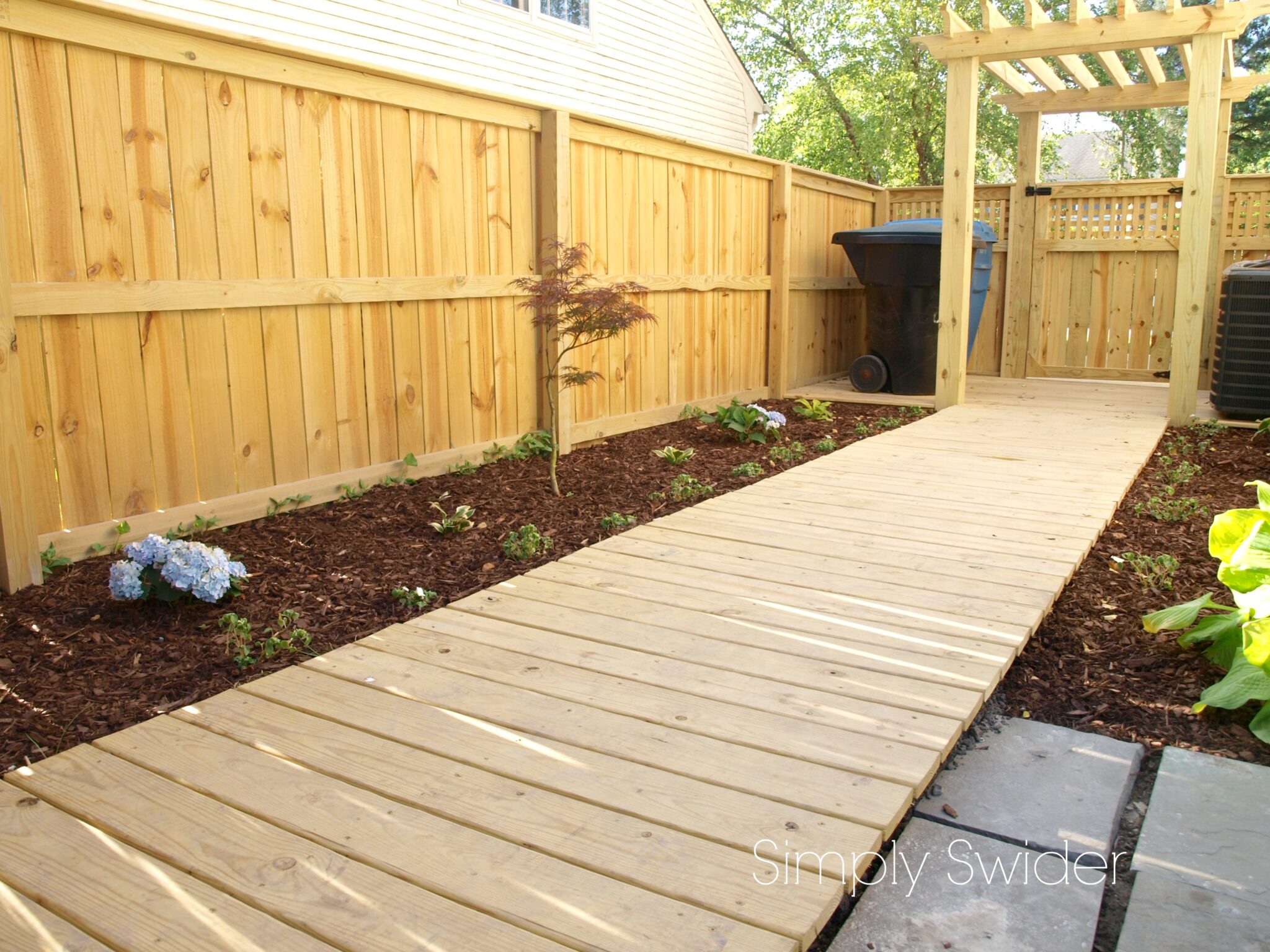 A beautiful fence and gate with an arbor - SimplySwider.com