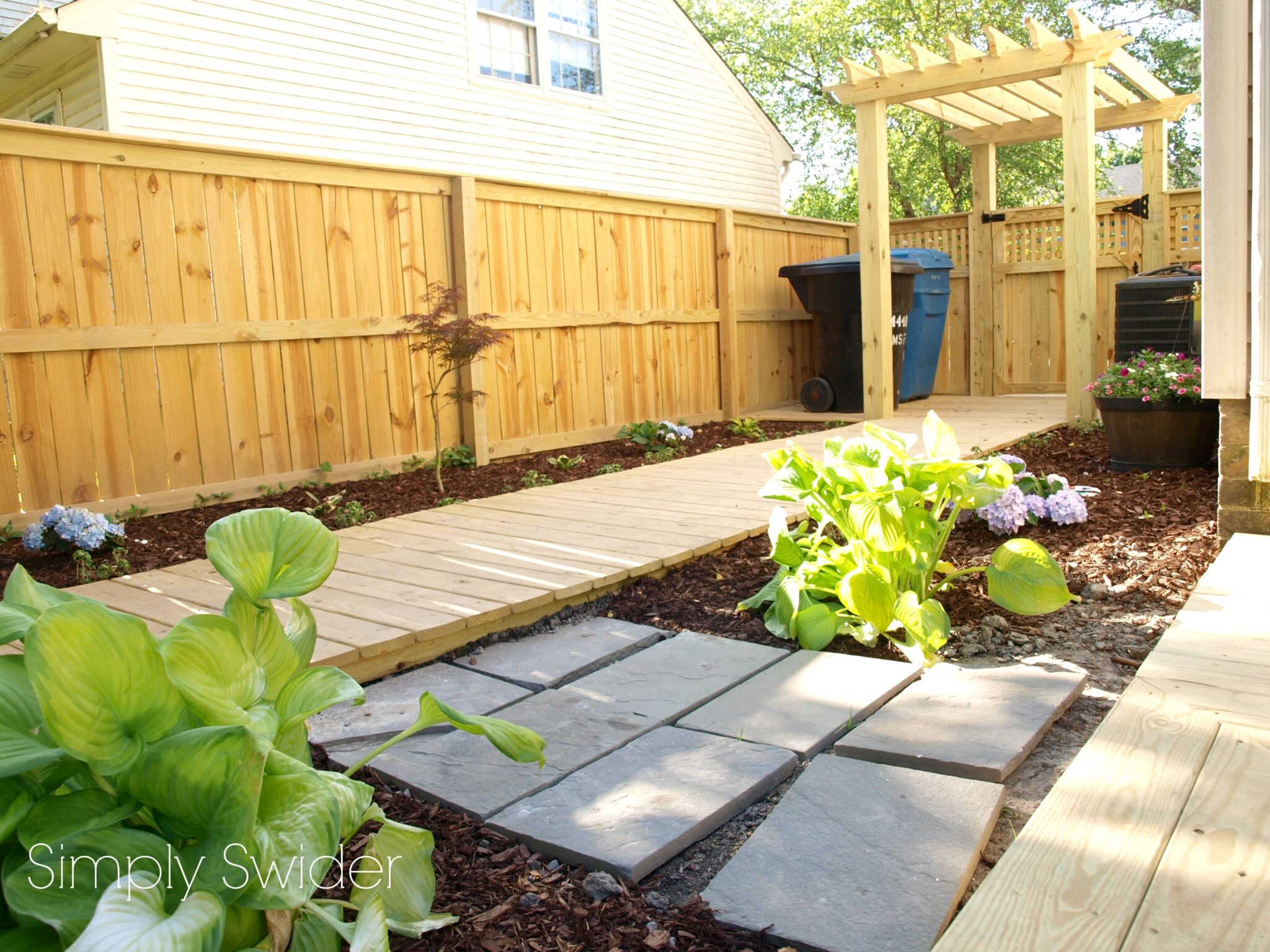 A beautiful fence and gate with an arbor - SimplySwider.com